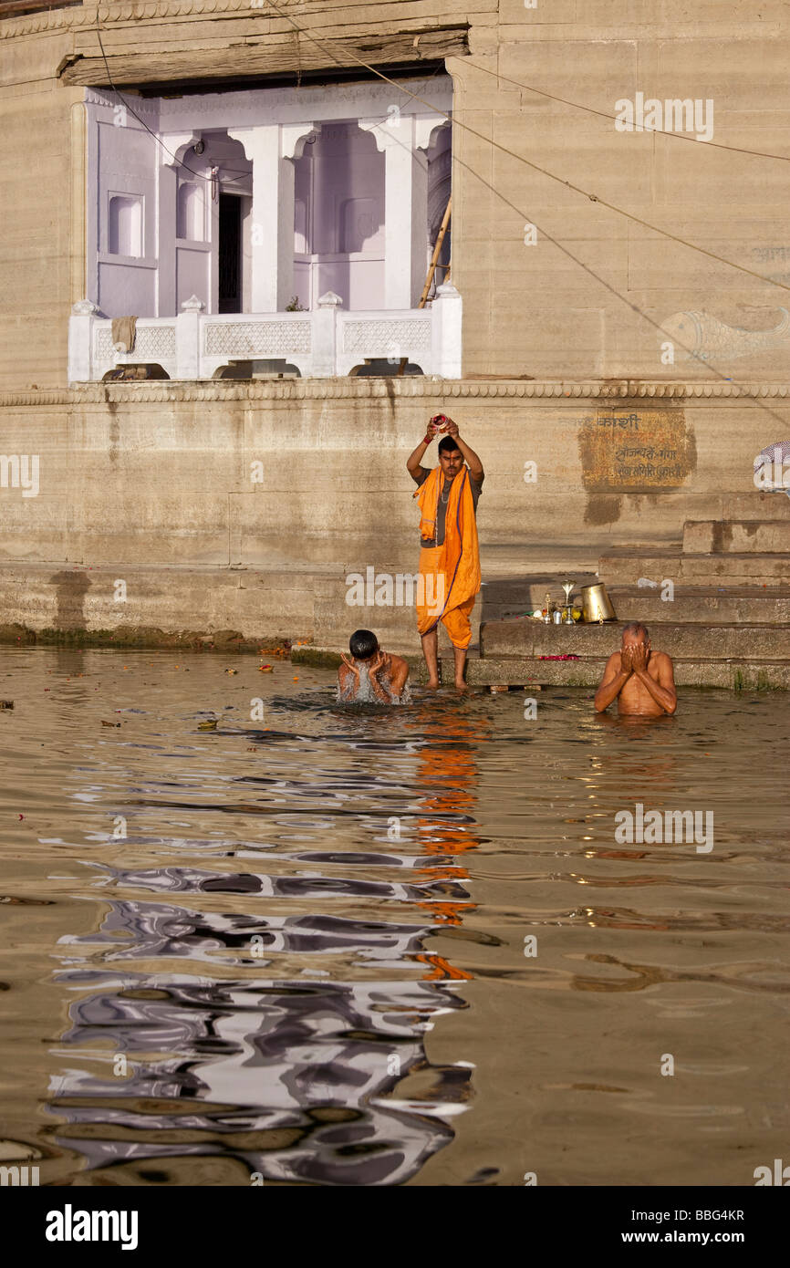 Hindu Men Bathing and Making Offering to the Ganges River in Varanasi ...