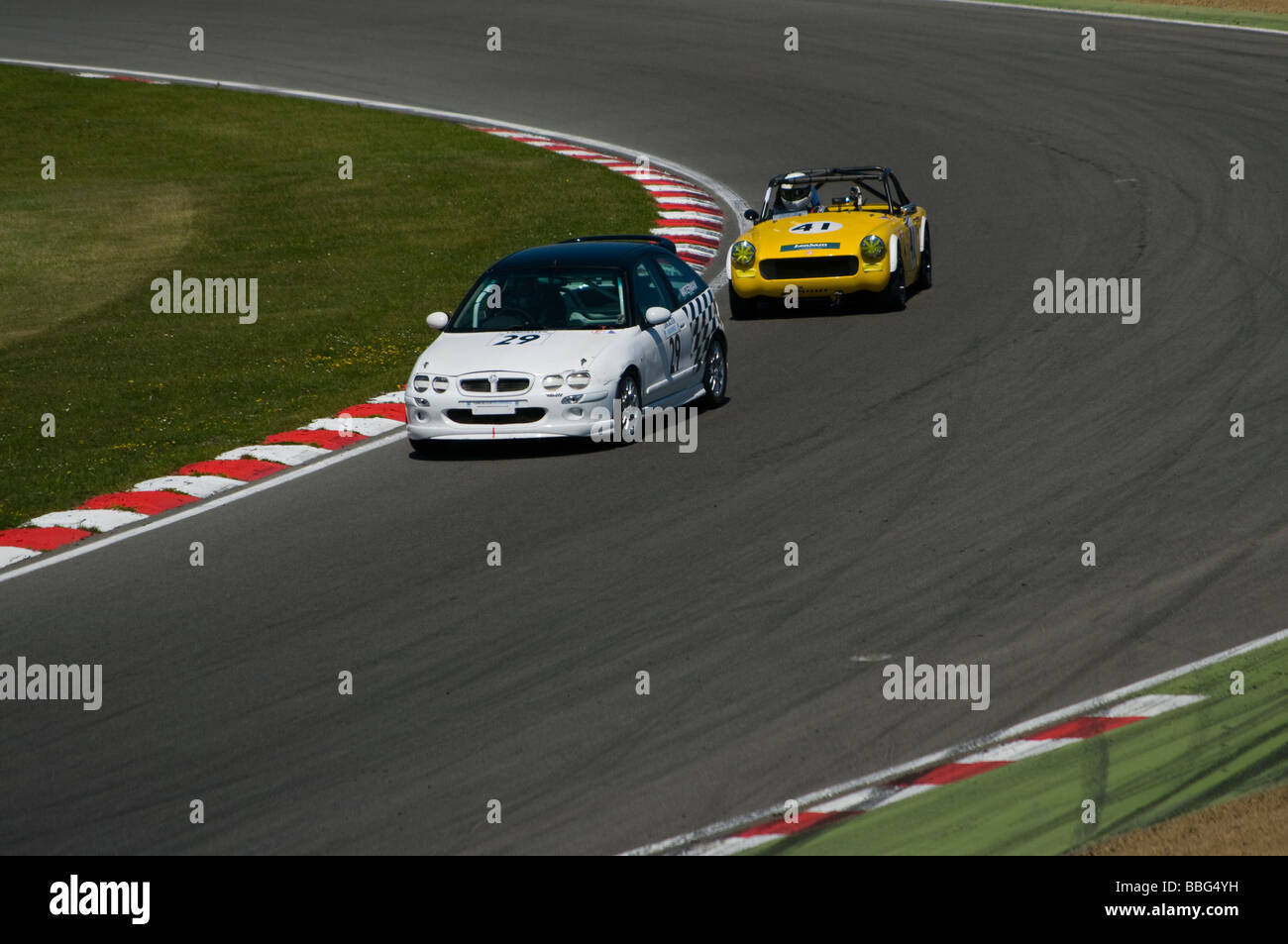 A White MG ZR 160 driven by Richard Waterman leading a Yellow MG Midget ...
