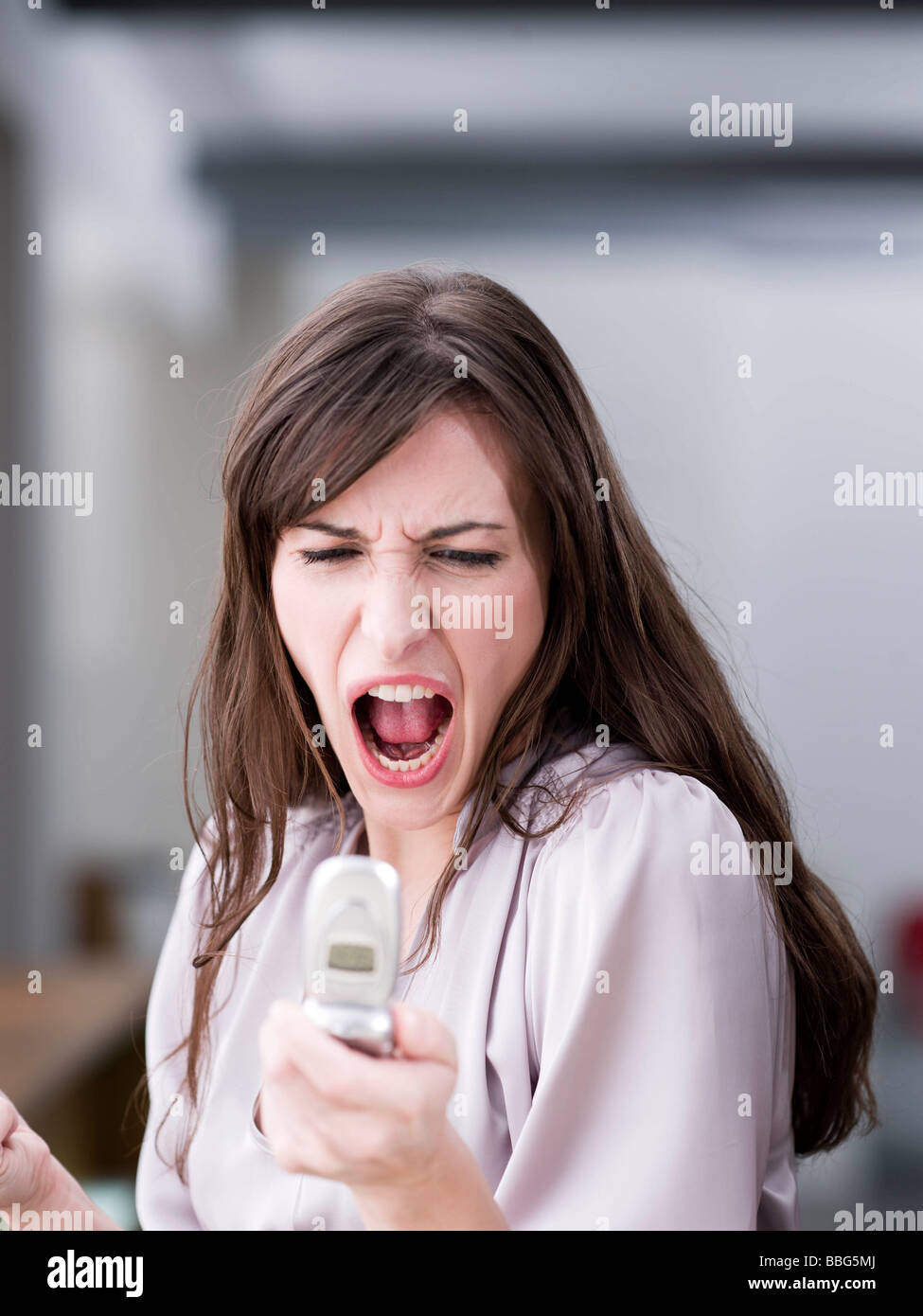 Woman shouting at phone Stock Photo - Alamy