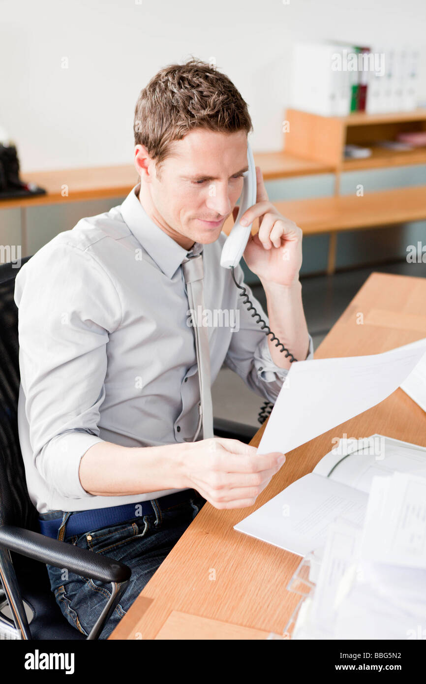 Man looking at papers Stock Photo - Alamy