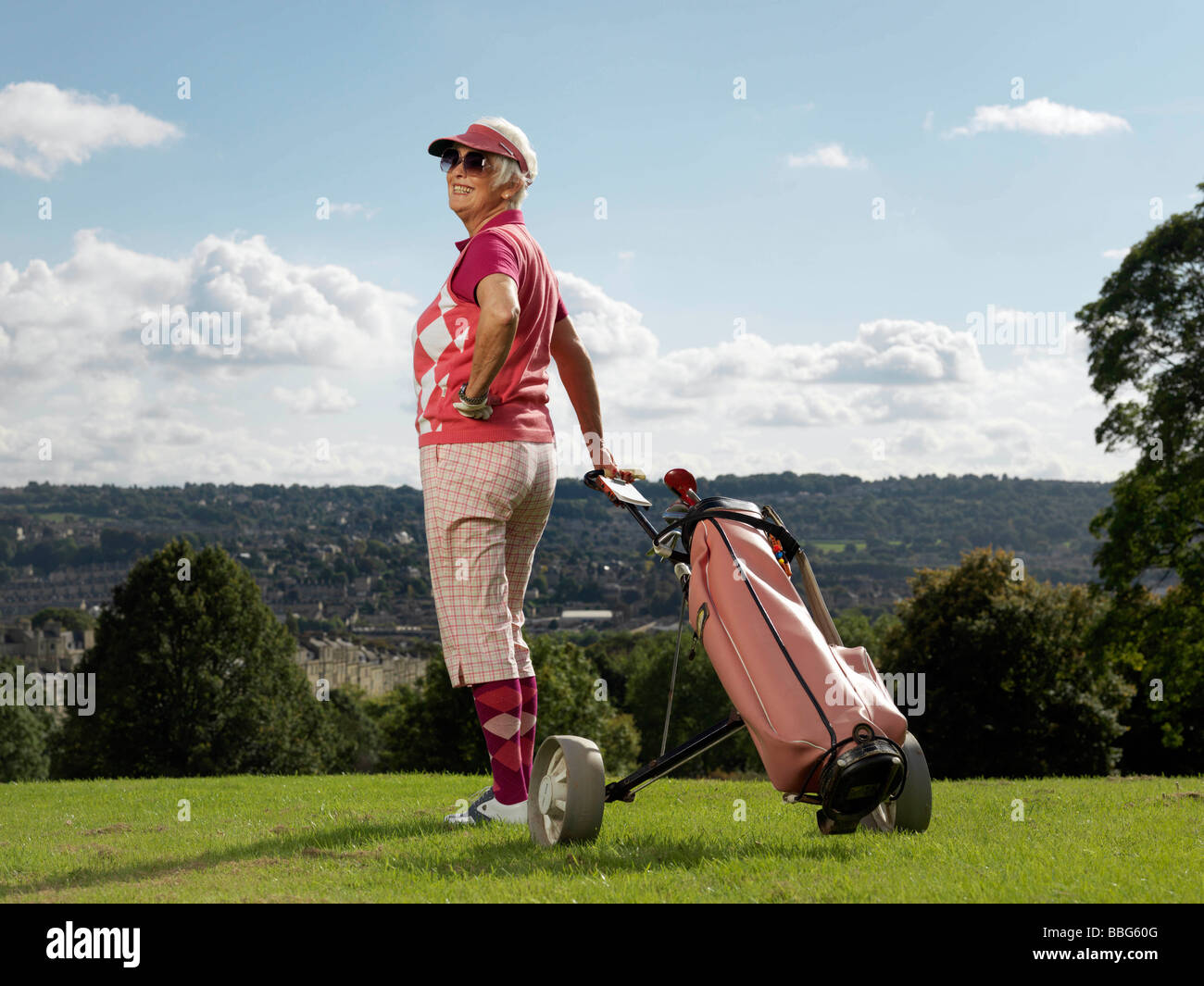 Mature lady playing golf Stock Photo - Alamy