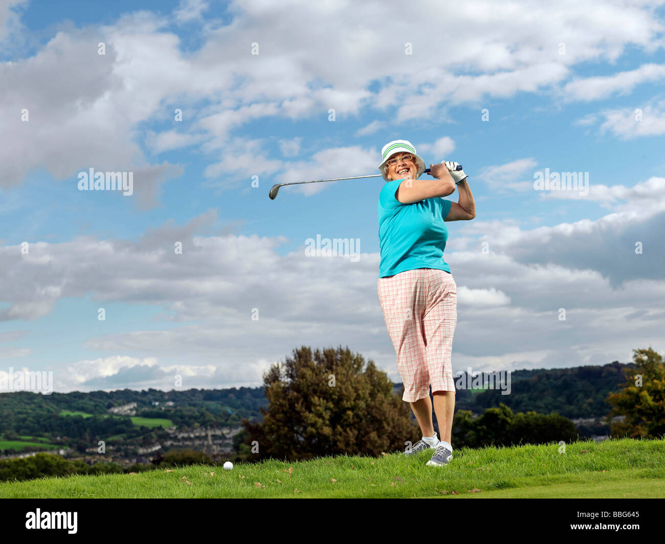Mature lady playing golf Stock Photo - Alamy