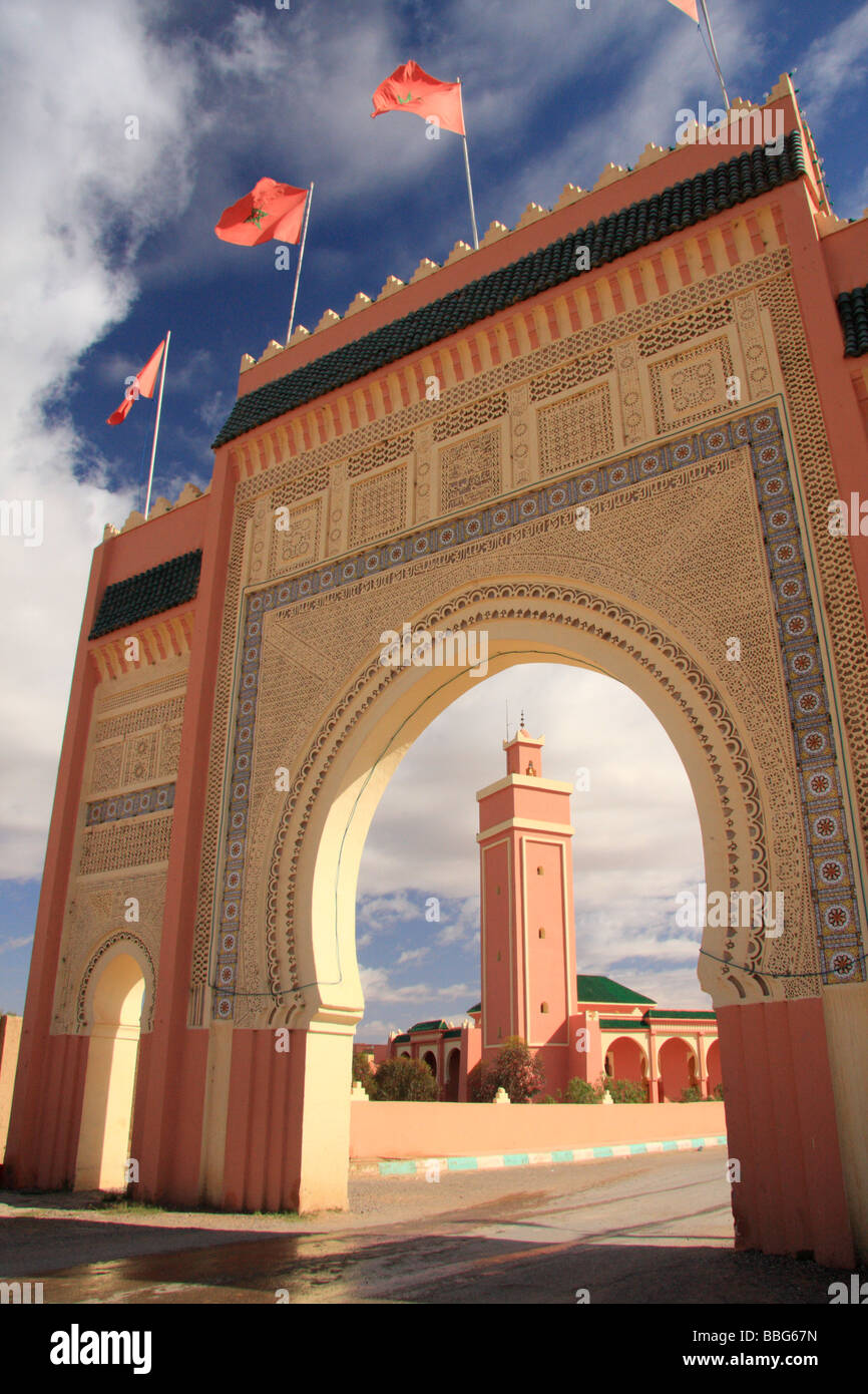 Keyhole arch entrance looking to a mosque at the entrance to Rissani ...