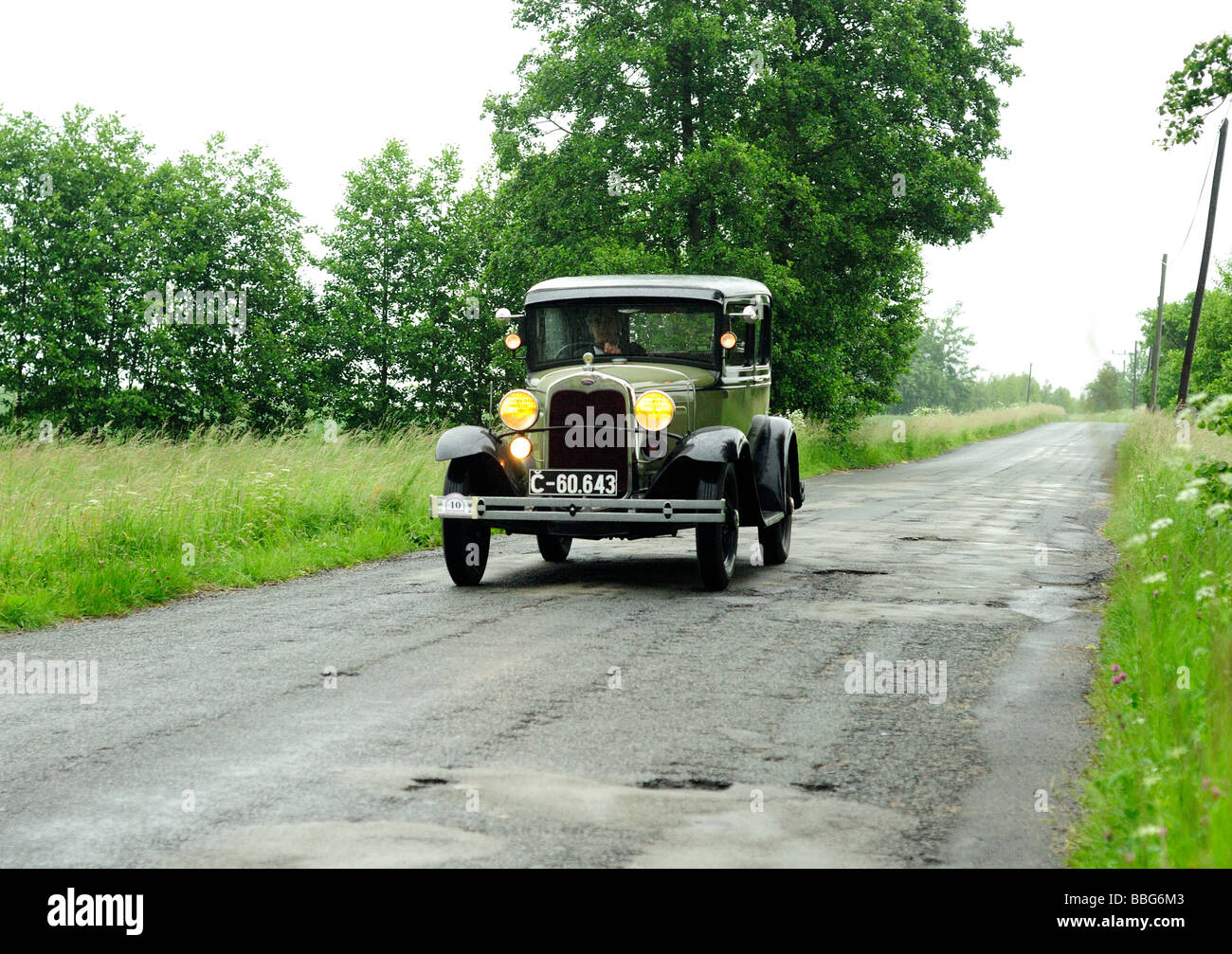 Vintage car on rural road Stock Photo - Alamy