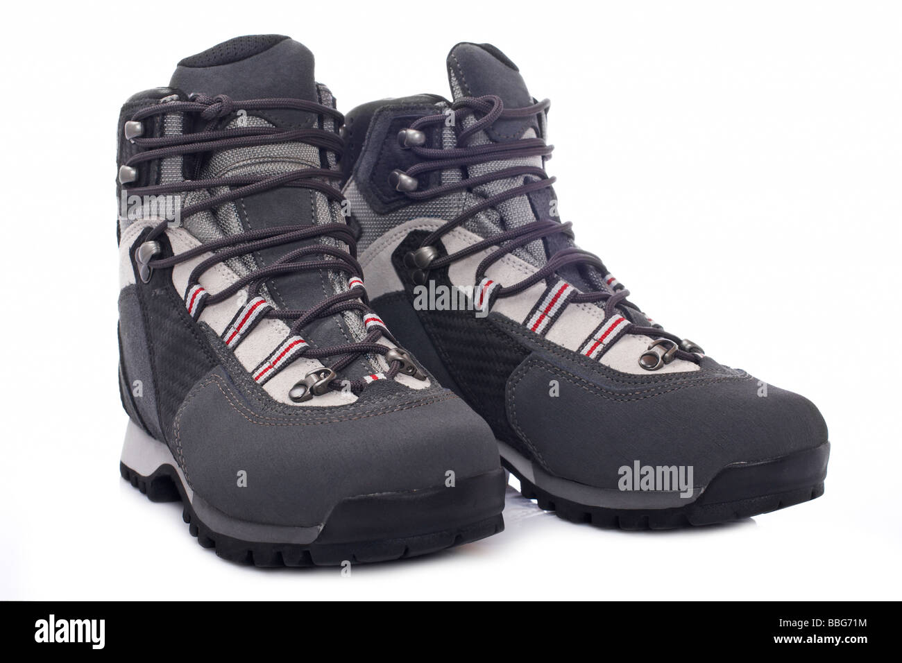 A pair of hiking boots with soft shadow reflected on white background ...