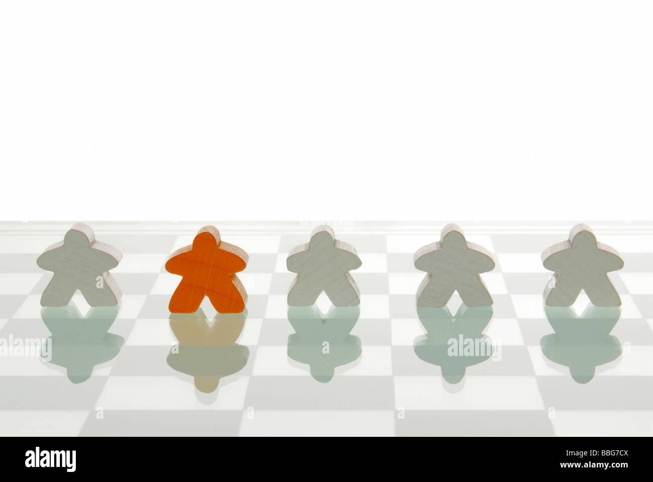 Game piece standing amidst different-coloured figures, symbolic of ...