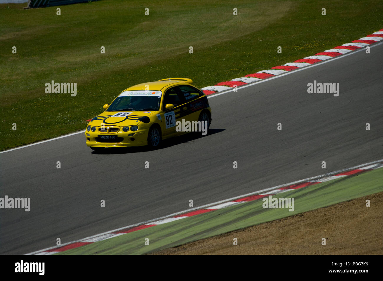A Yellow MG ZR 160 driven by Helen Waddington rounding Paddock Hill ...