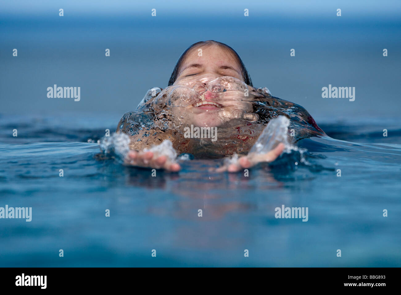 Girl surfacing in a swimming pool Stock Photo - Alamy