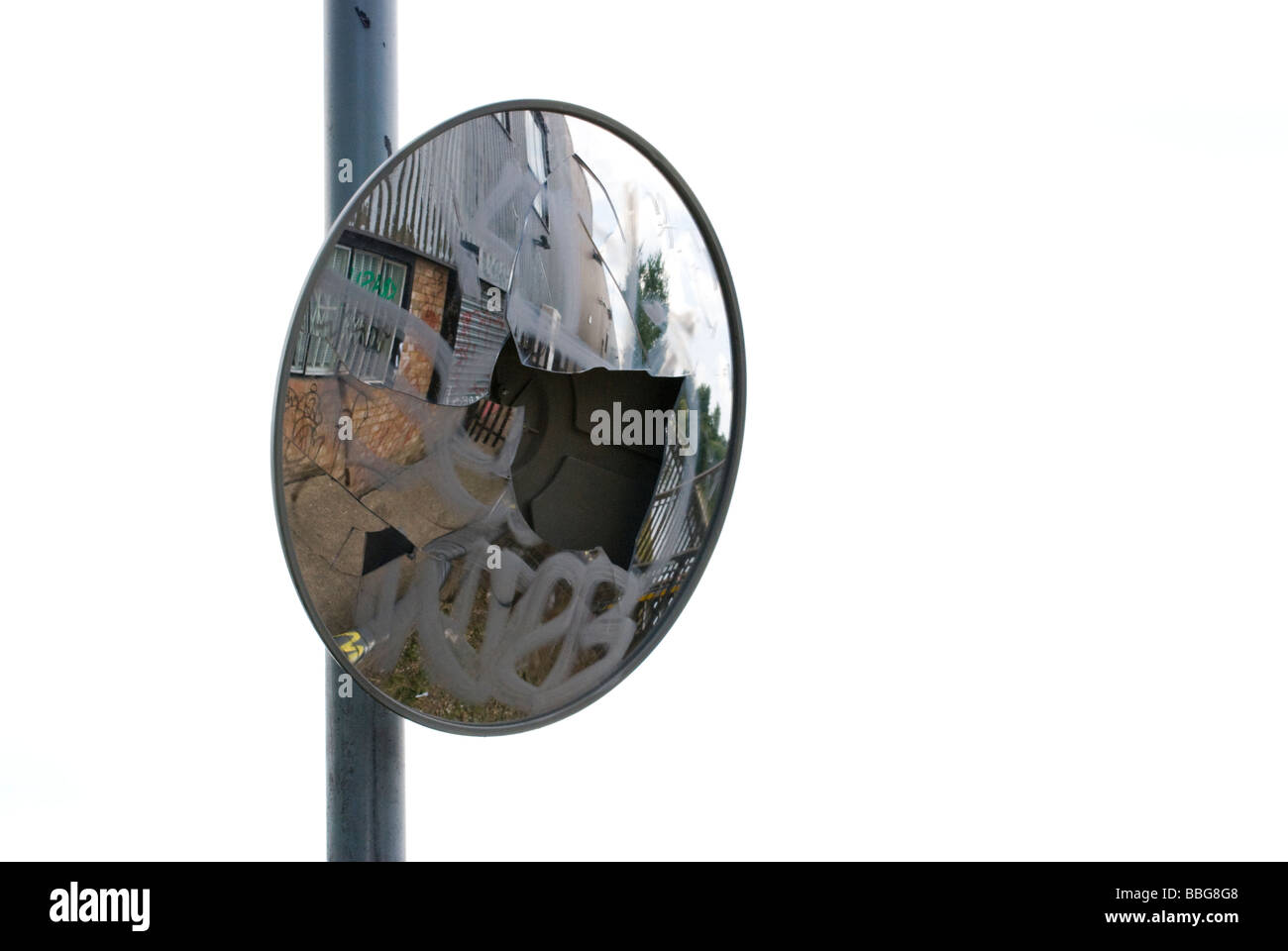 A vandalised security mirror on a city street Stock Photo - Alamy