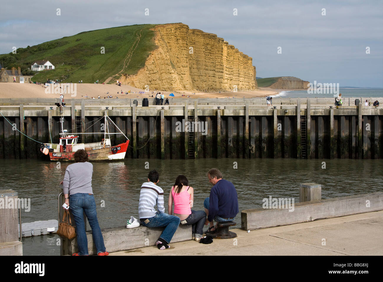 people crab fishing in harbour west bay seaside town dorset england uk ...