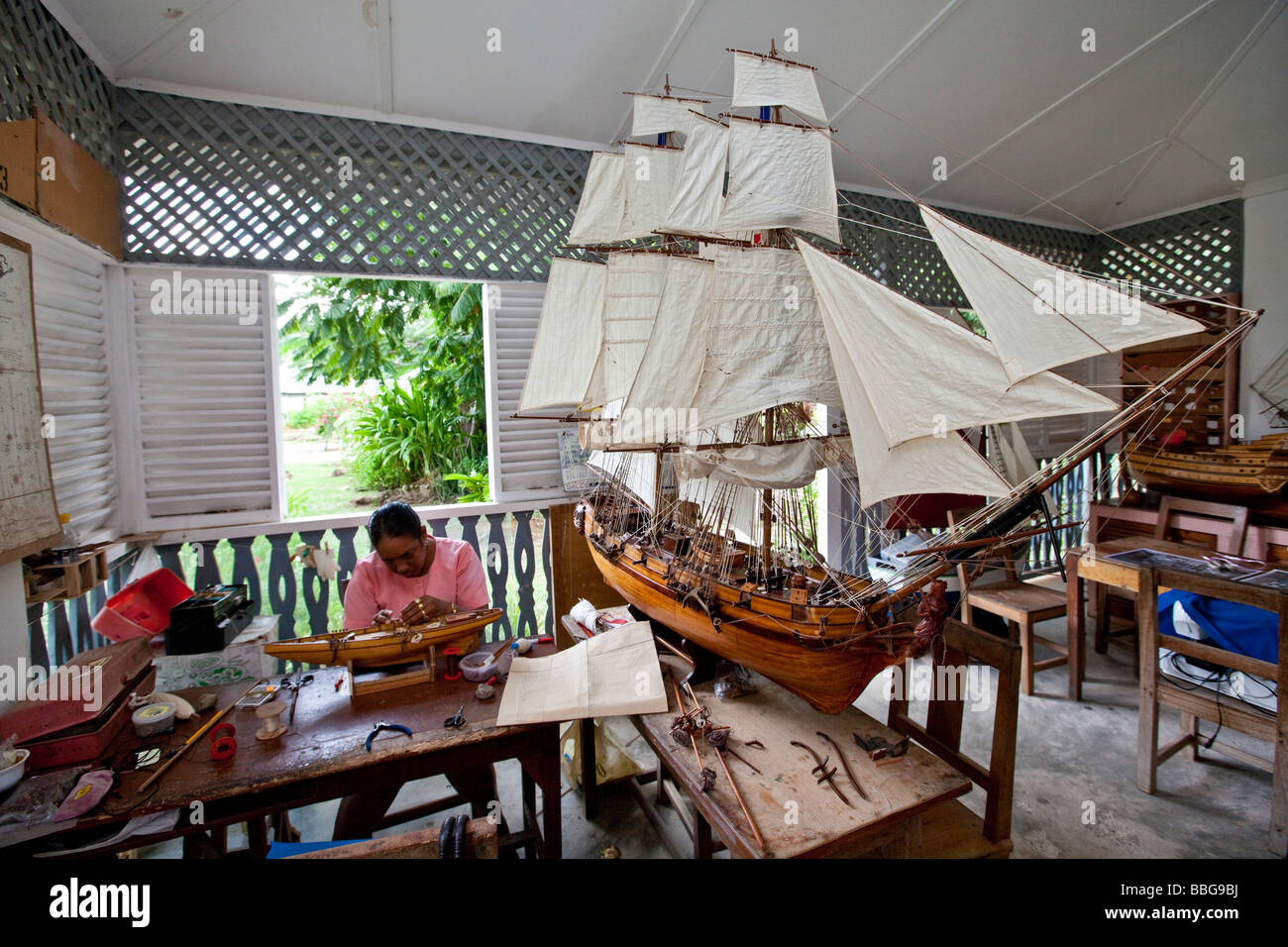 A woman making a miniature sailing ship, Craft Village, handicrafts of ...