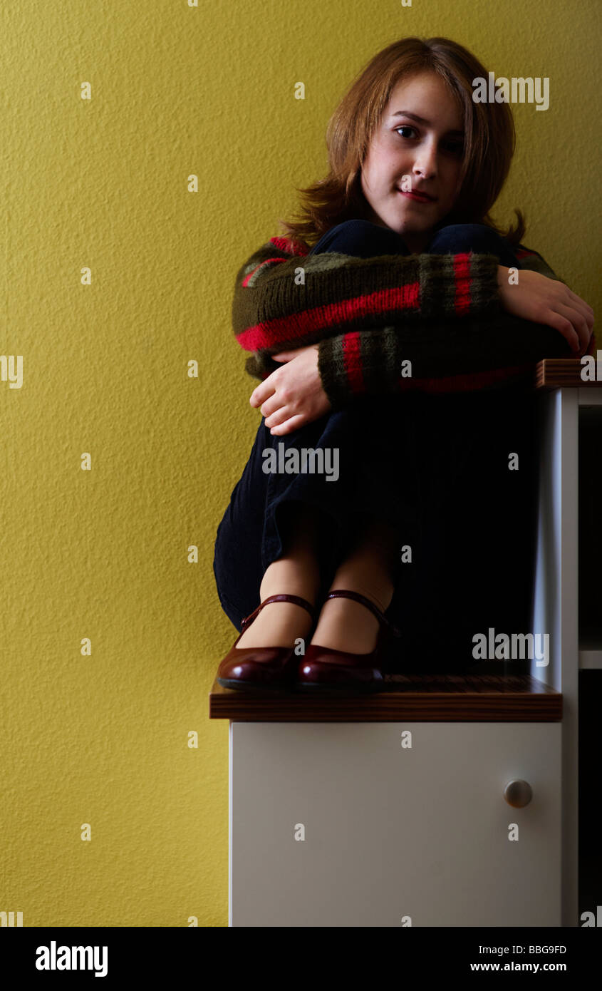 Young girl sitting on a step Stock Photo - Alamy