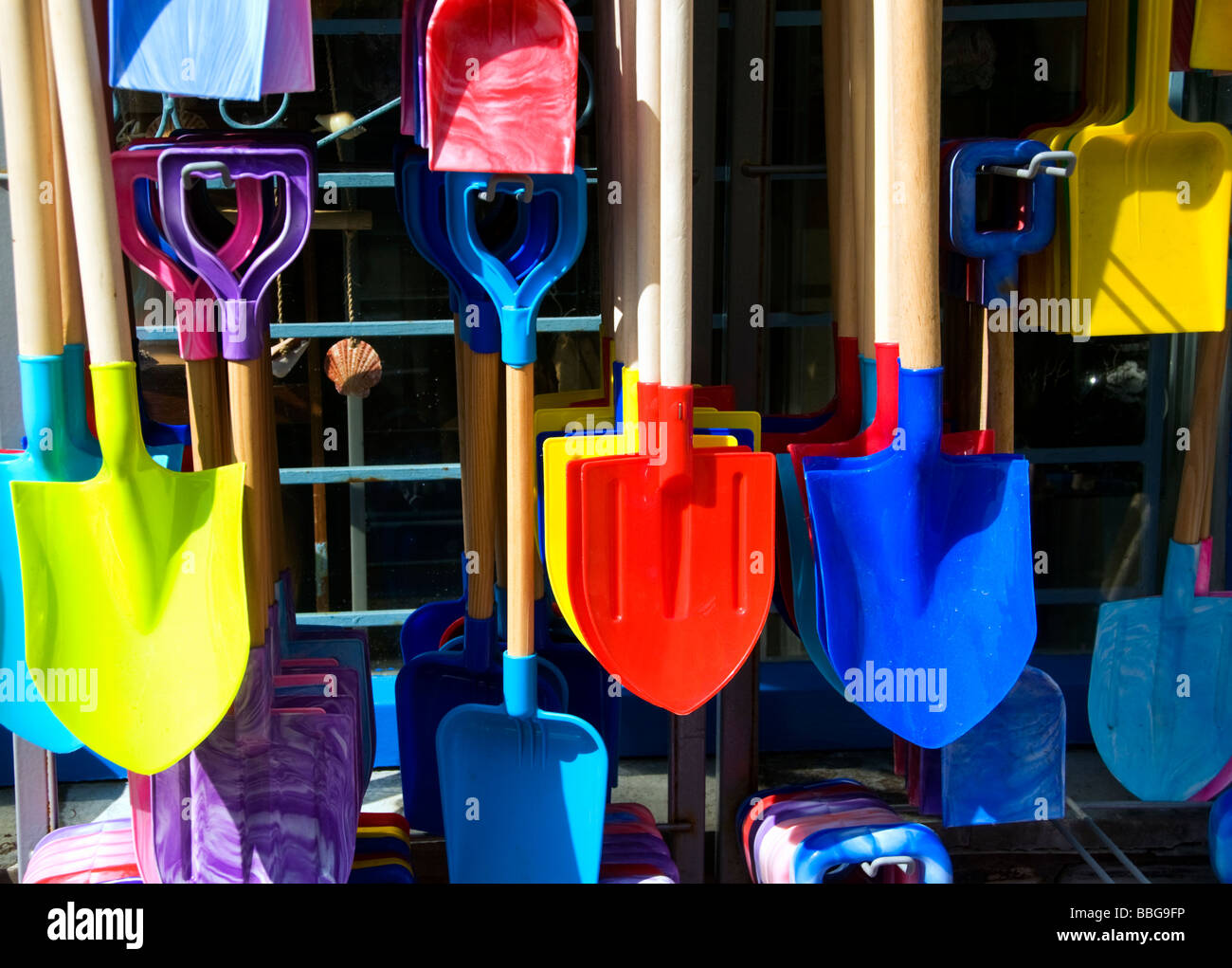 Colourful plastic spades on sale at a beach stall in Cornwall, UK Stock ...