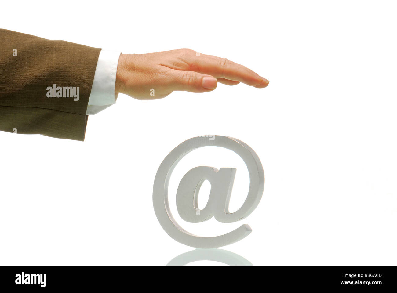 Business man holding hand over at-sign, symbolic of protection in the ...