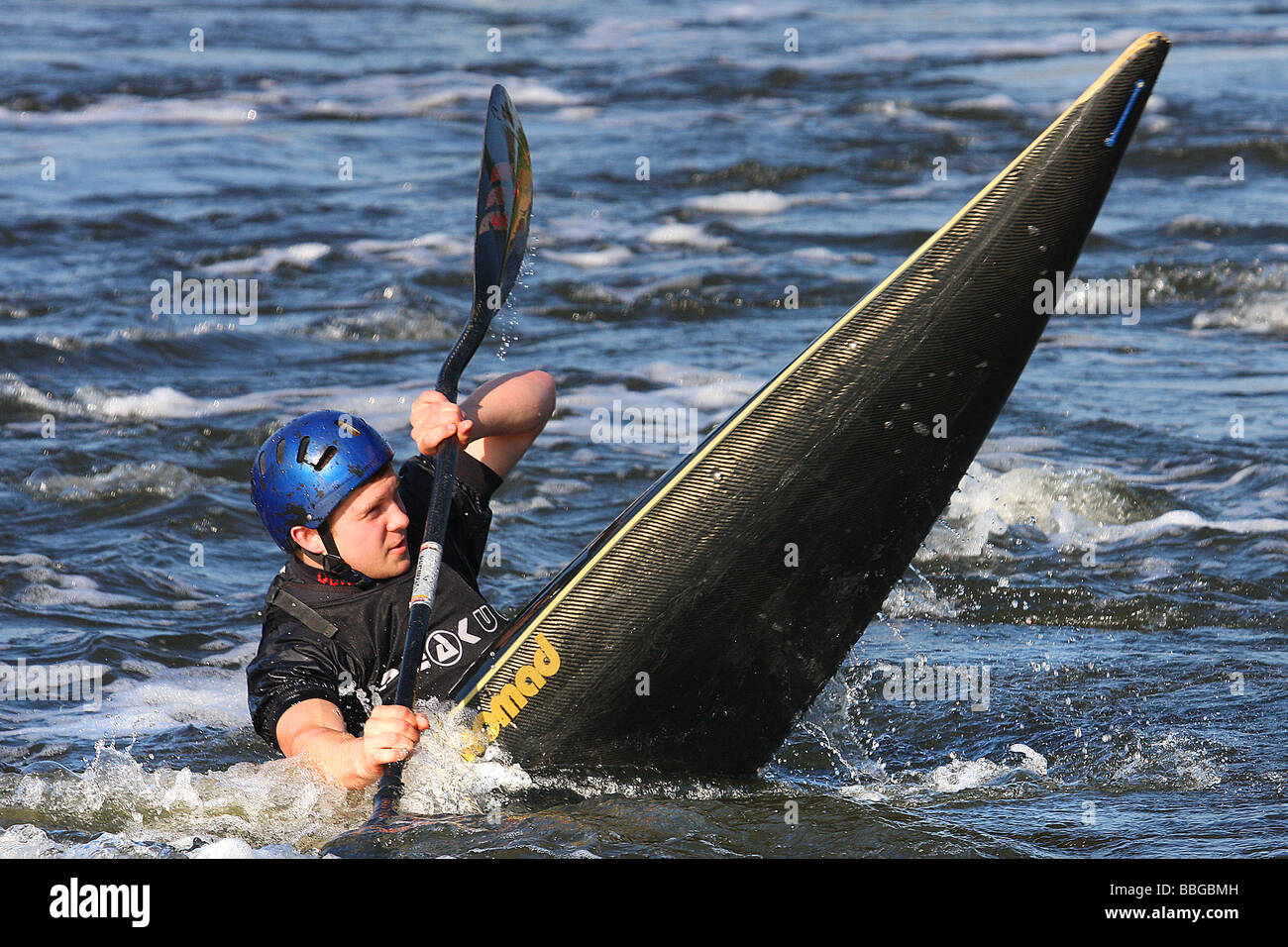 Canoeist fights for control in white water Stock Photo - Alamy
