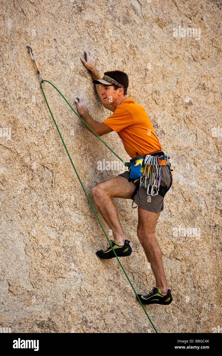 Climber ascends a steep rock overhang Stock Photo - Alamy