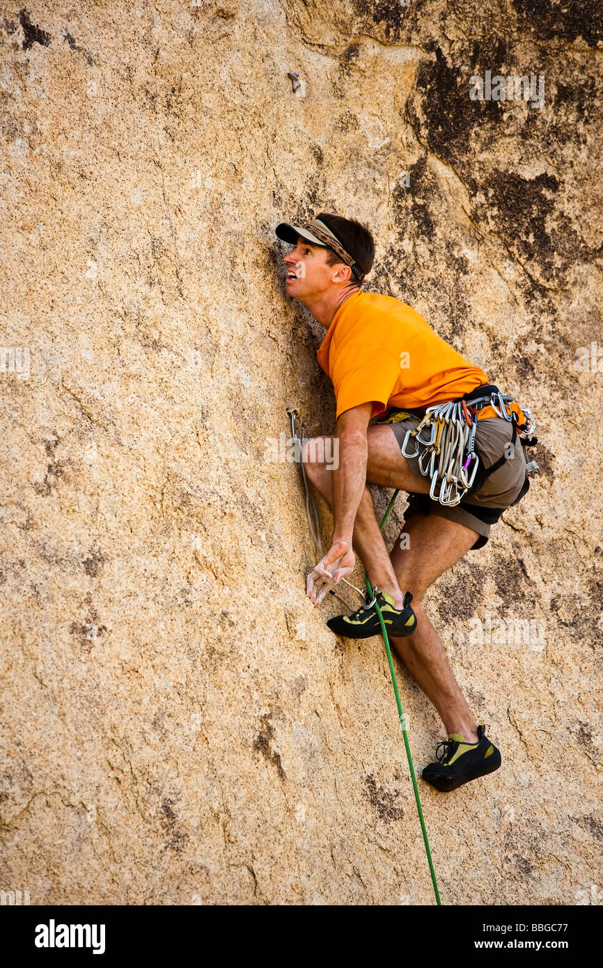 Climber ascends a steep rock overhang Stock Photo - Alamy
