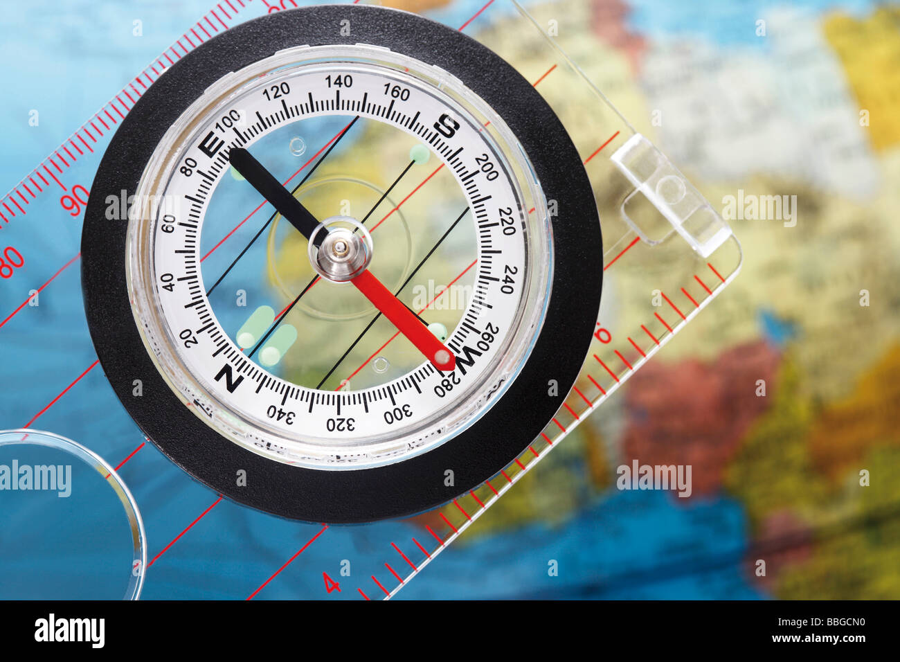 Compass on globe Stock Photo - Alamy