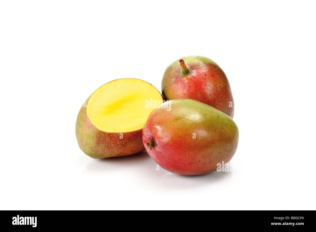 Two mangos and a cut one Stock Photo - Alamy