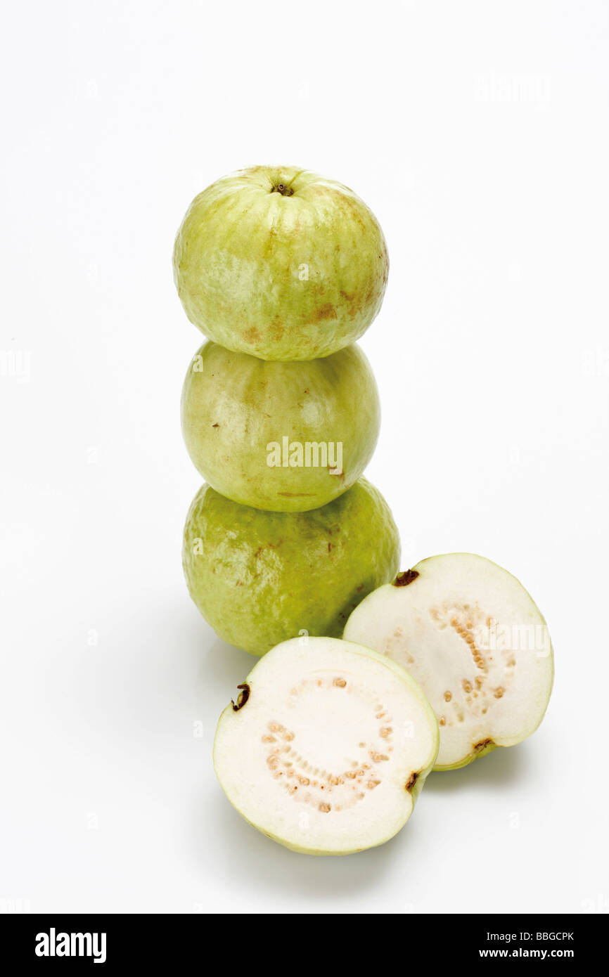 Three stacked guavas, one halved Stock Photo - Alamy