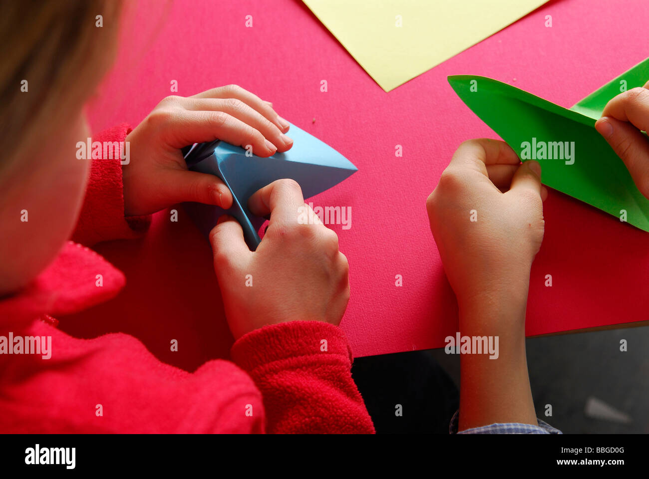 Children's hands folding origami Stock Photo - Alamy