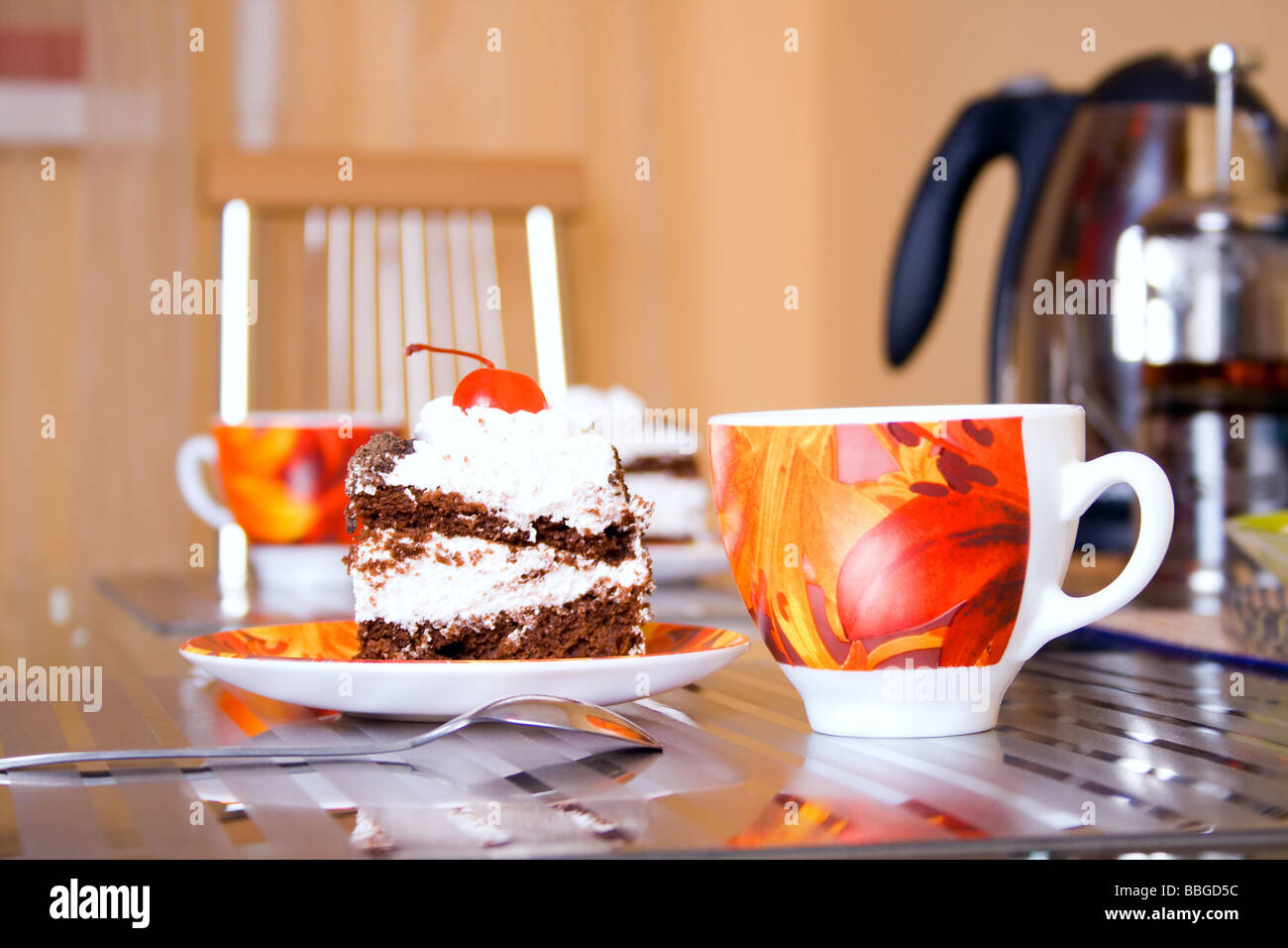 Tea cup and cake on a kitchen table Stock Photo - Alamy
