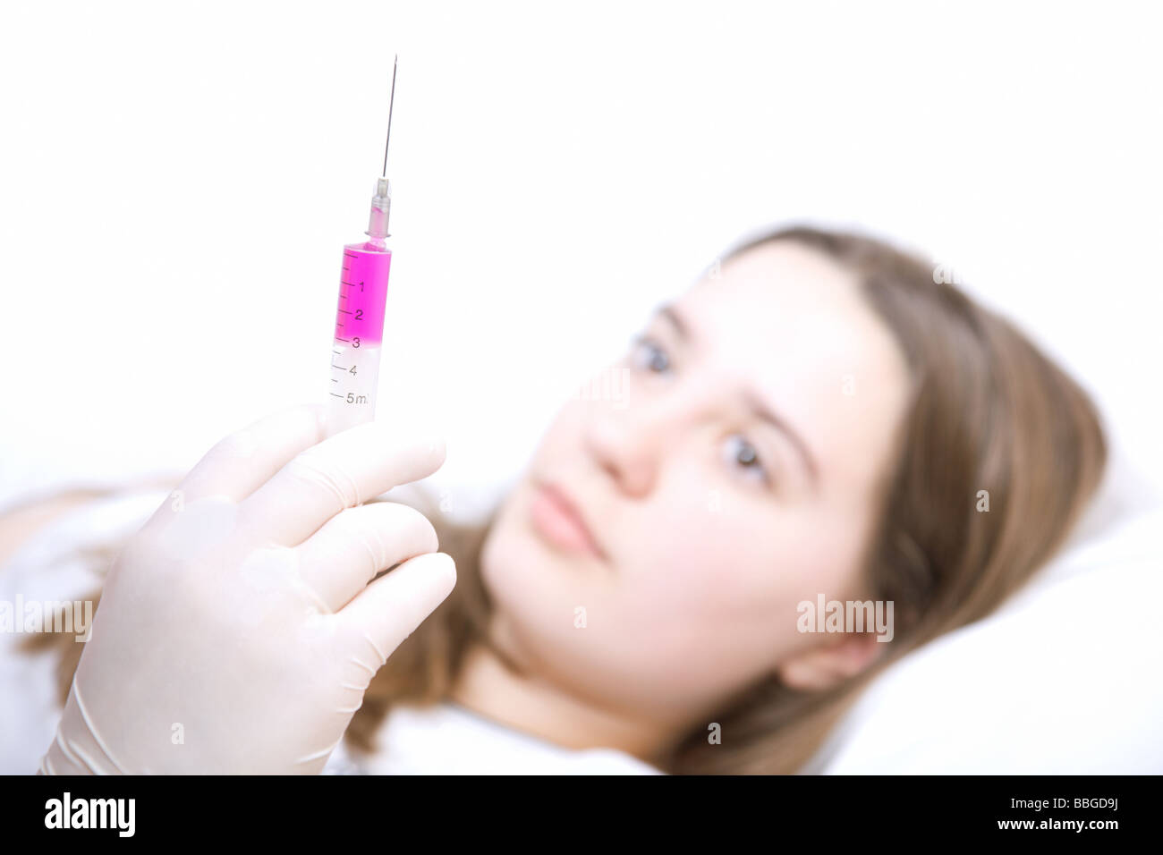 Doctor taking syringe and vaccination young patient Stock Photo - Alamy