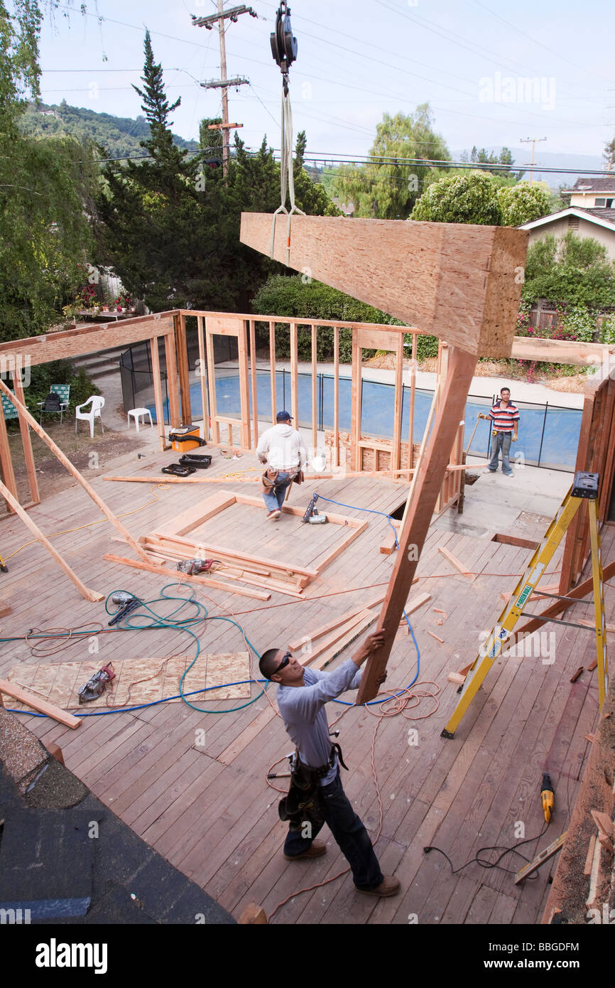 Giant ridge beam being held by a crane and swiveled into position by a ...