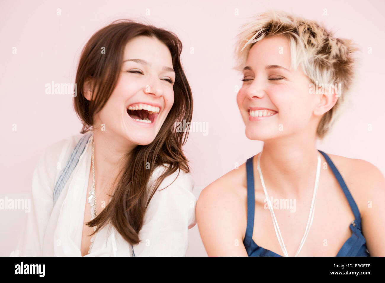 Girls laughing together Stock Photo - Alamy