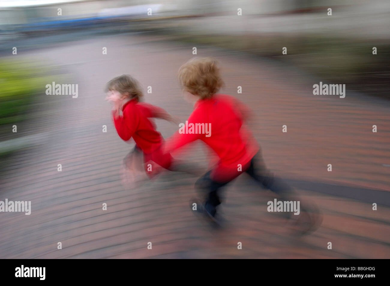 Two boys running and playing taken with a slow shutter speed Stock ...