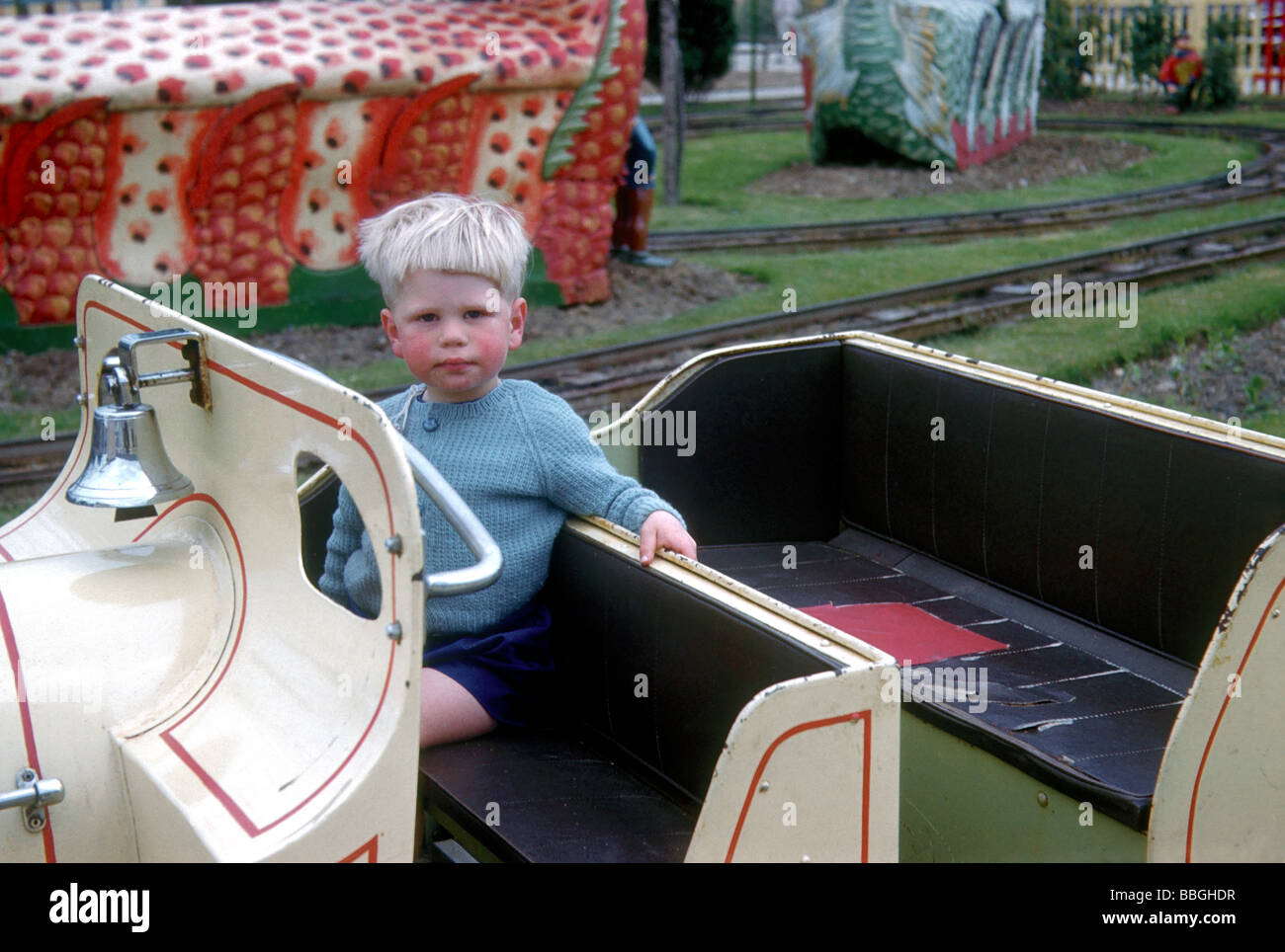 Colin Walton as a young toddler sat miserably in a toy train at the ...