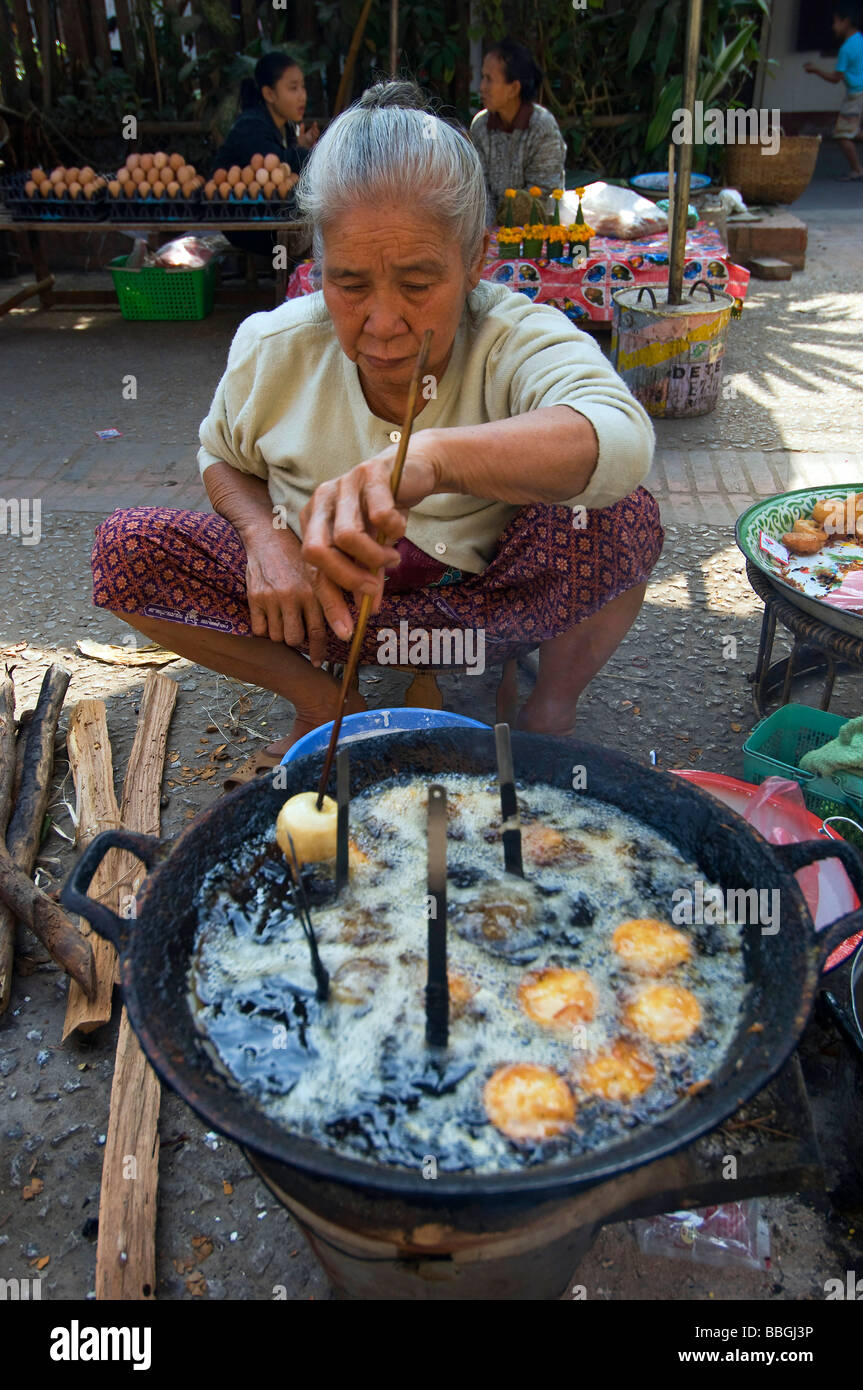 Old woman frying snacks at the market hi-res stock photography and ...