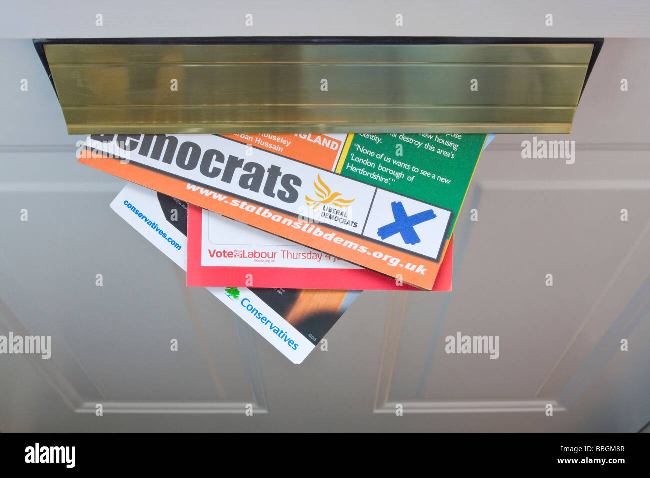 Election leaflets coming through a letterbox Stock Photo - Alamy