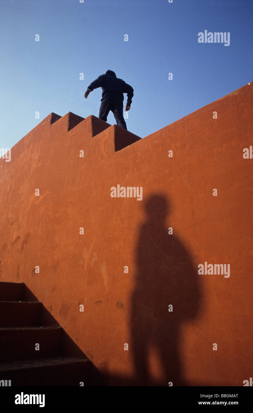 Rear view and shadow of a man climbing steps, Janter Manter, New Delhi ...