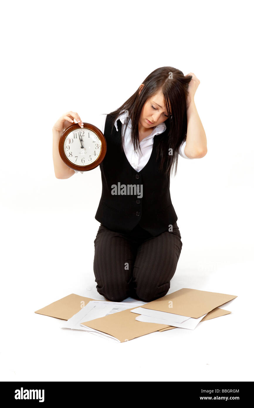 Attractive young brunette business woman holding clock and pulling her ...