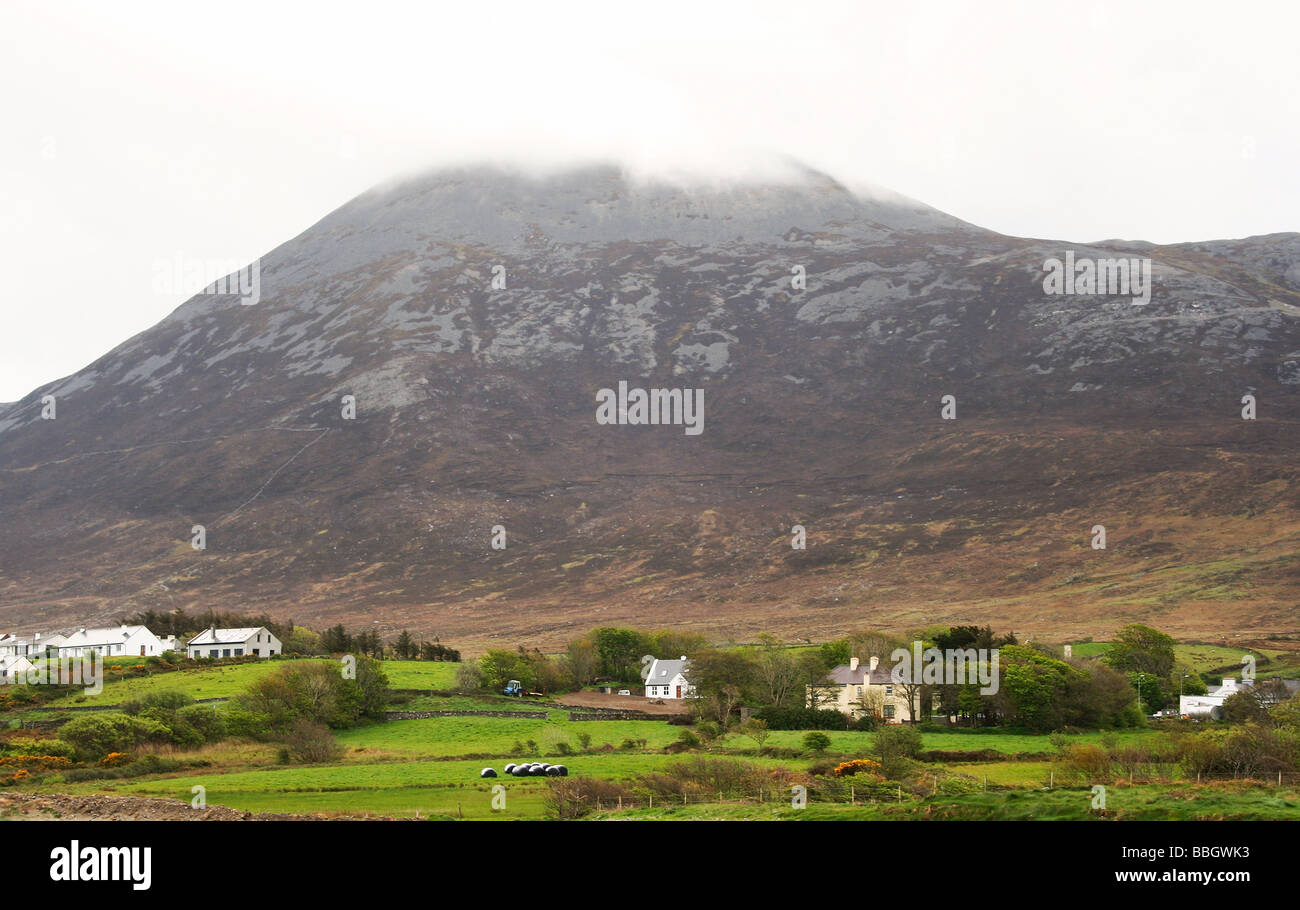 Croagh Patrick Mountain, top covered in cloud. Cottages and farmland ...