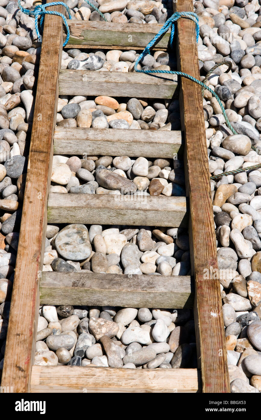 Wooden Ladder on shingle beach Stock Photo - Alamy