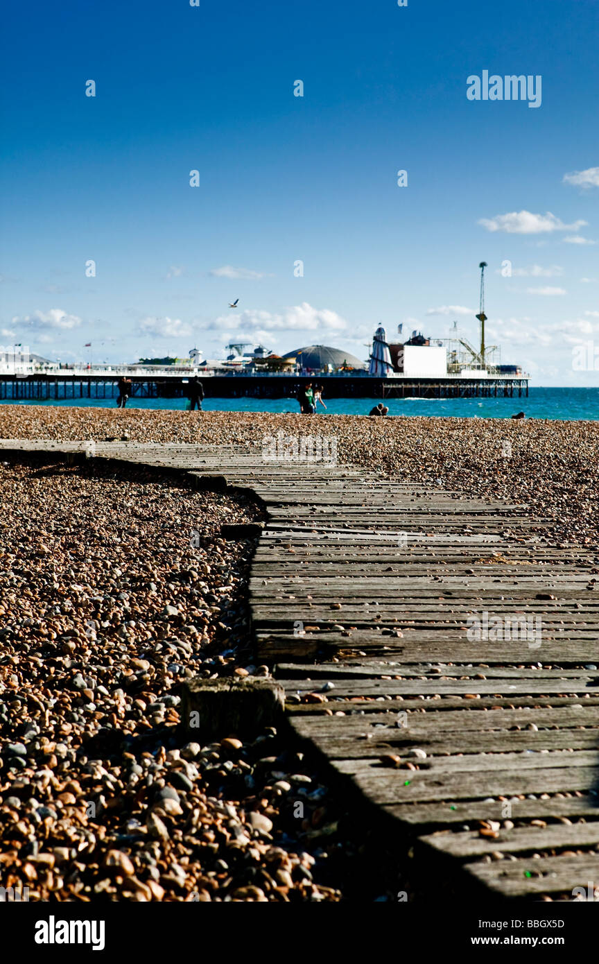 A timber boardwalk on Brighton beach, with a view of Brighton Pier in ...