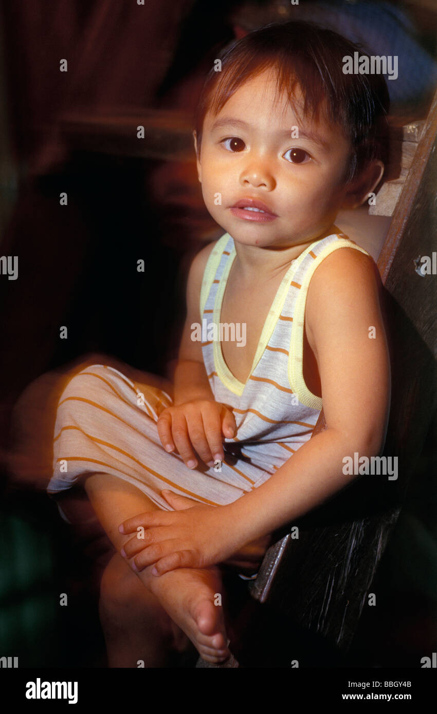 Young child sitting Stock Photo - Alamy
