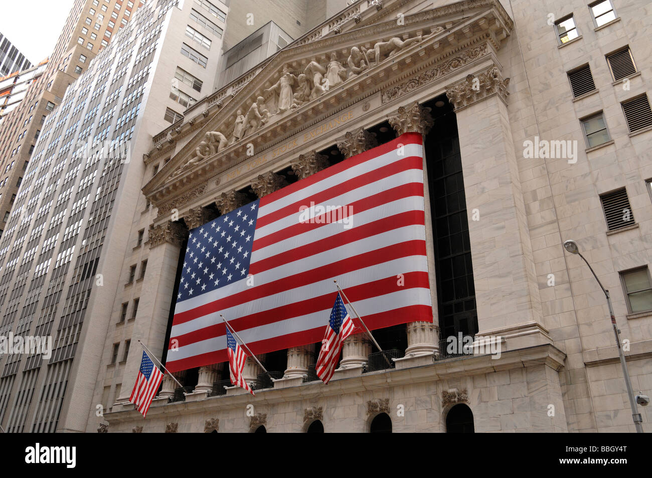 New York stock exchange building with giant Stars and Stripes flag ...