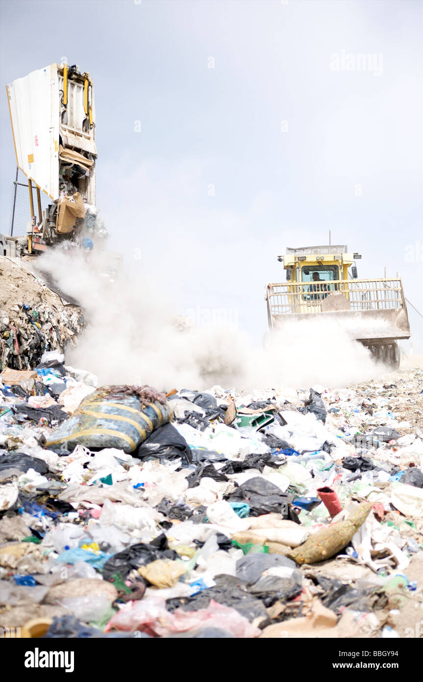 Heavy equipment moving piles of trash at the dump Stock Photo - Alamy