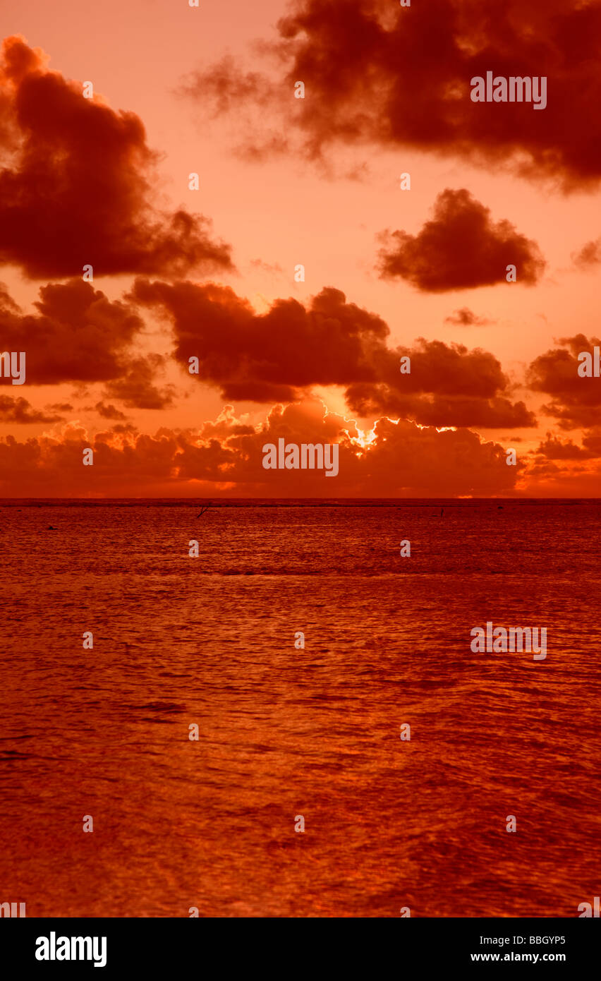 Sun sinks to Sea under a cloud filled Sky at Sunset Rarotonga Cook ...