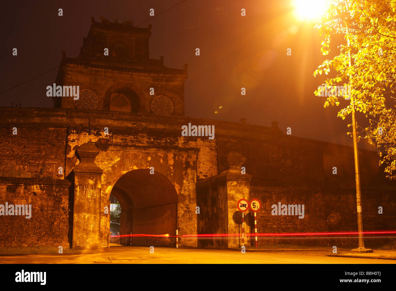 Light trails from a motorbike passing through the "Ngan Gate" at night ...
