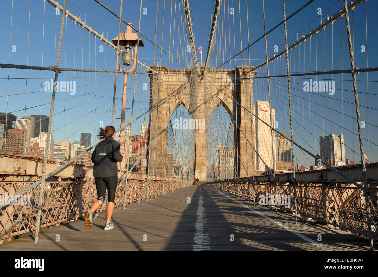 Runner jogging on the Brooklyn Bridge New york City NY USA Stock Photo ...