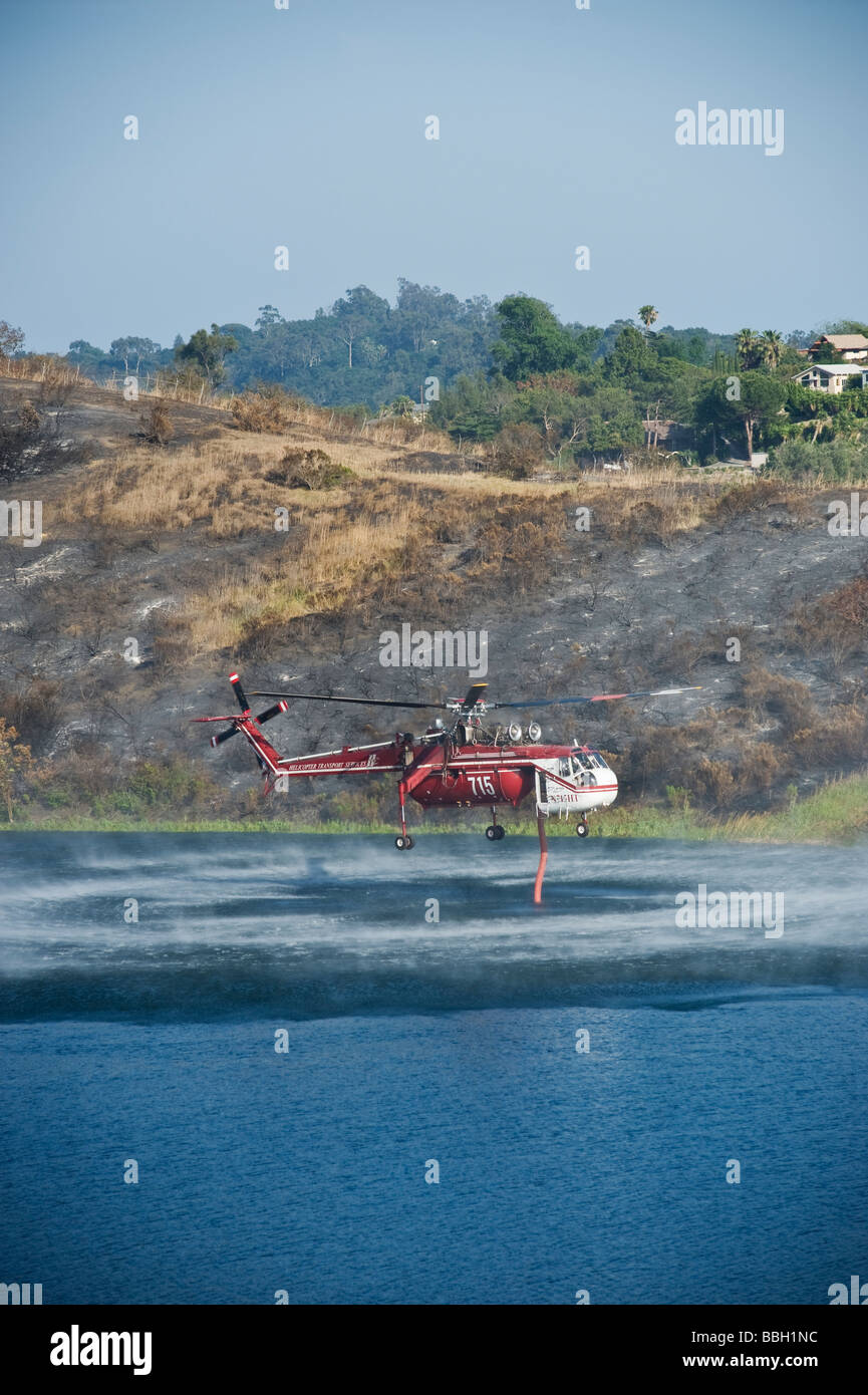 FIre fighting helicopter takes on water from Lauro Reservior during ...