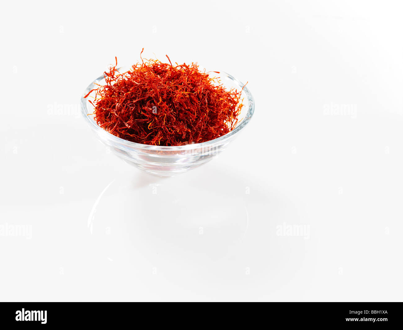 Saffron in glass bowl on a white studio background Stock Photo - Alamy