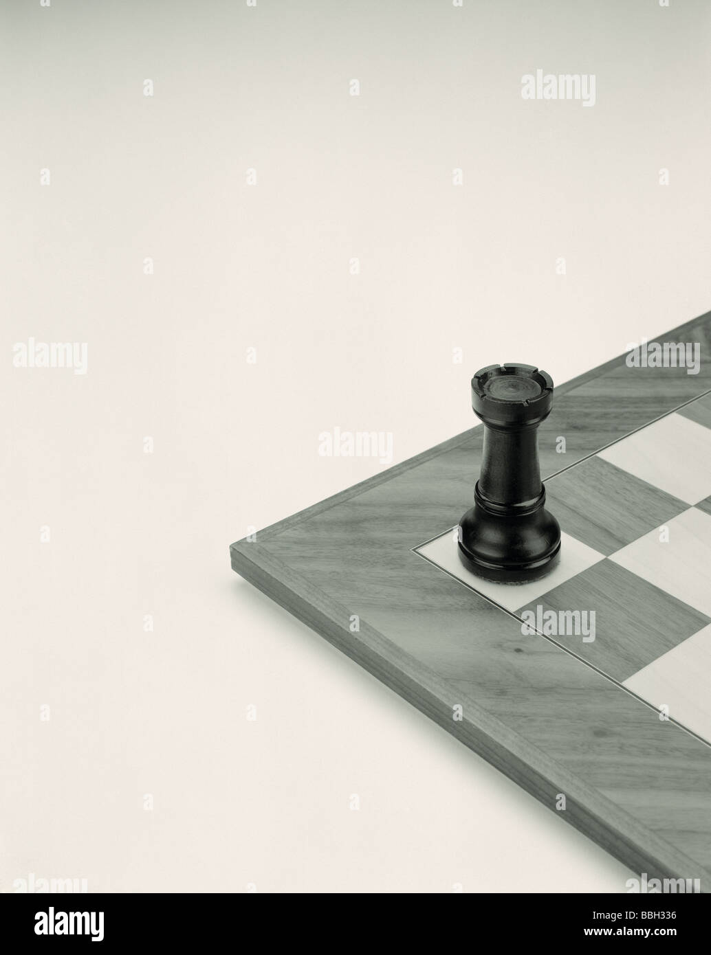 Black Castle chess piece on black and white chessboard Stock Photo - Alamy