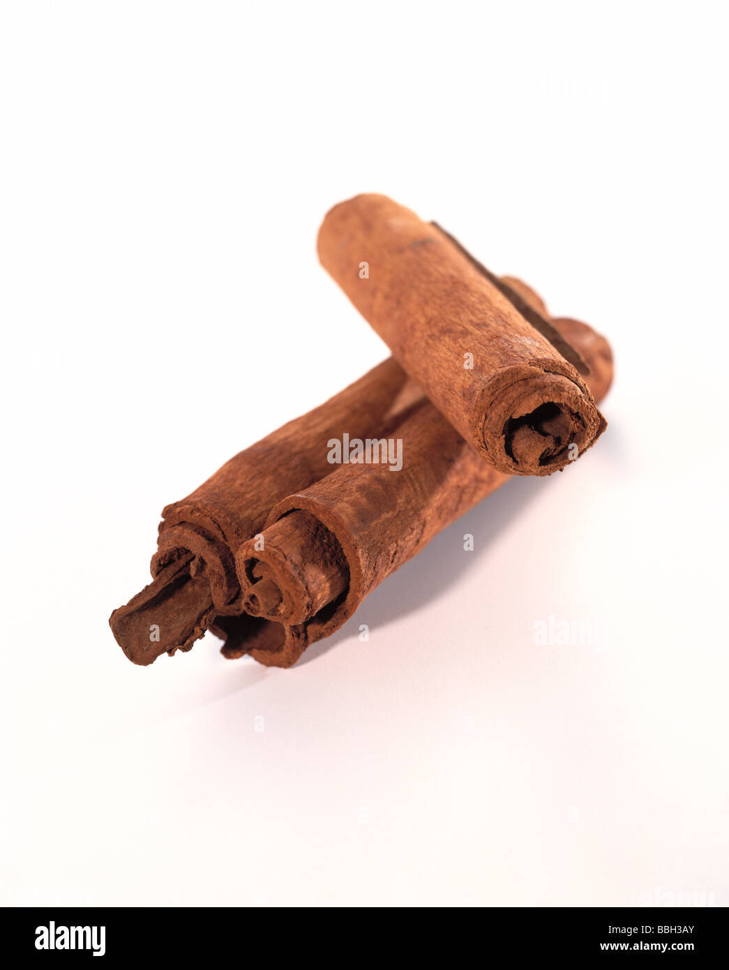 Cinnamon sticks overlaying on white studio background Stock Photo - Alamy