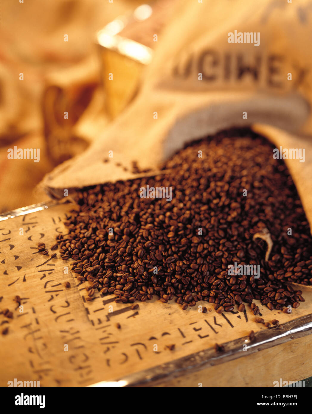 Roasted coffee Beans spilling out of linen bag onto box Stock Photo - Alamy