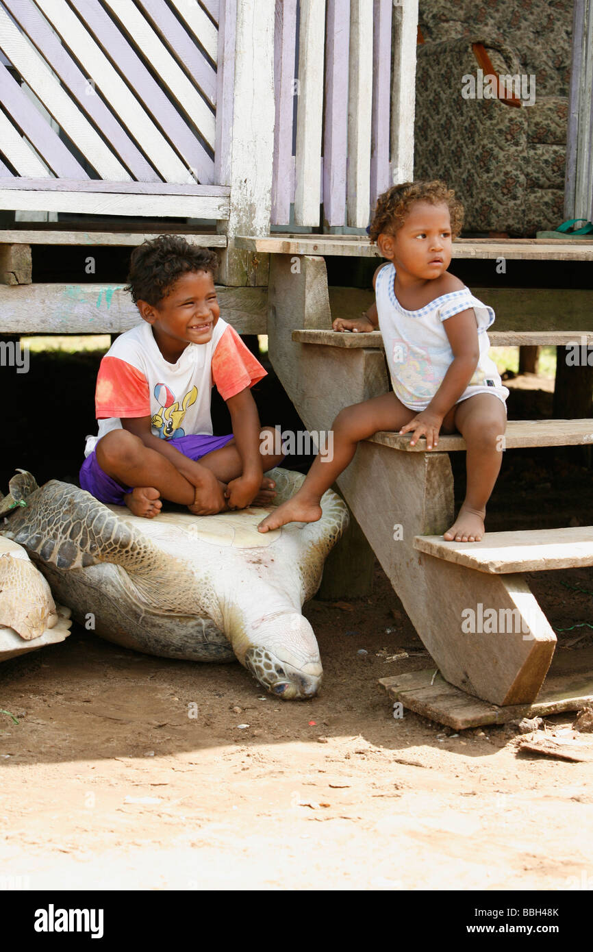 Children sitting on sea turtles hi-res stock photography and images - Alamy